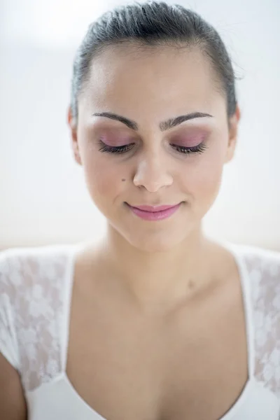 Portrait focused young woman stretching in studio - Stock Image ...