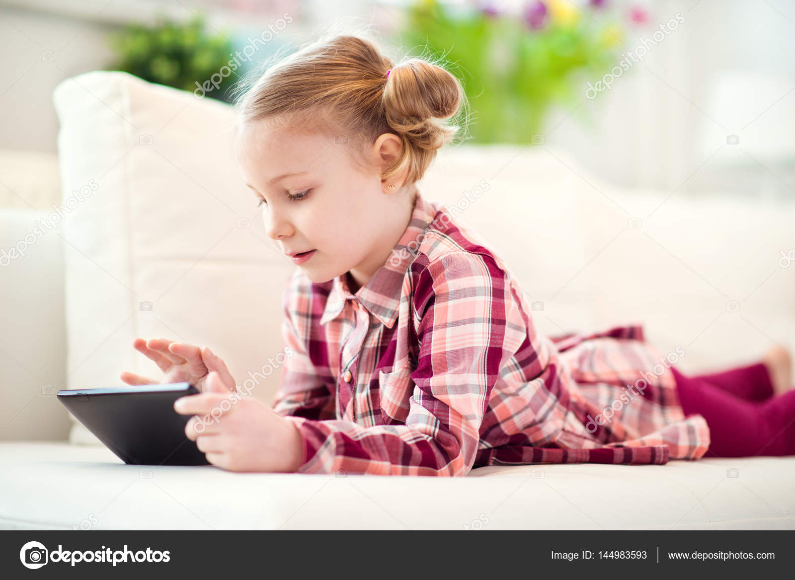 Pretty little child girl using a digital tablet, looking and sm Stock ...