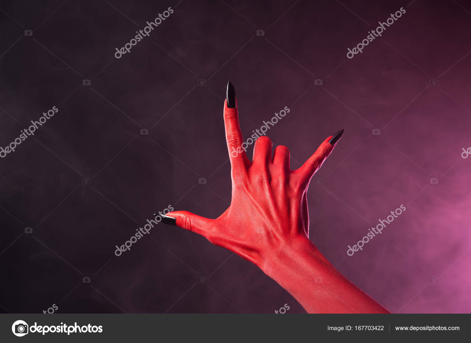 Mano roja del diablo con clavos negros: fotografía de stock © Elisanth ...