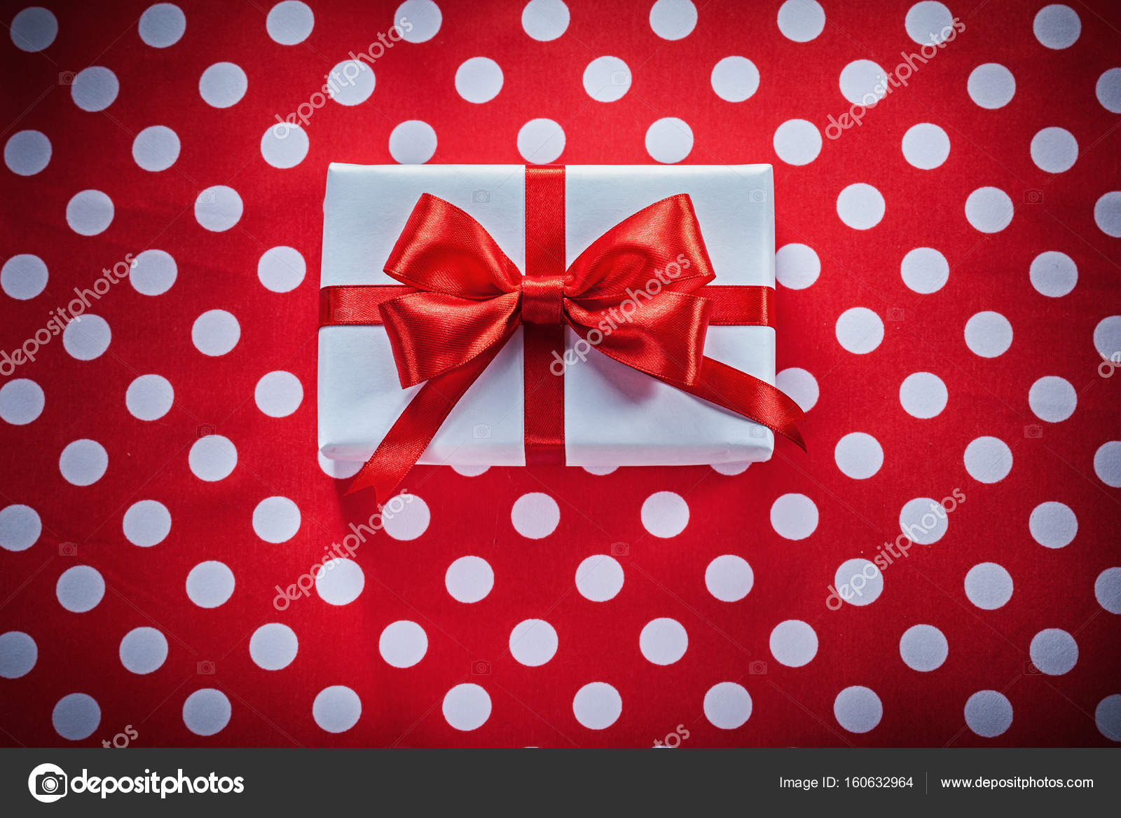 White gift box with knot on polka-dot red fabric holidays concep Stock ...