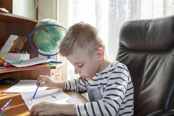 School-age boy crying and screaming while doing homework. the co Stock ...