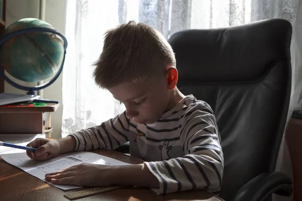 School-age boy crying and screaming while doing homework. the co Stock ...