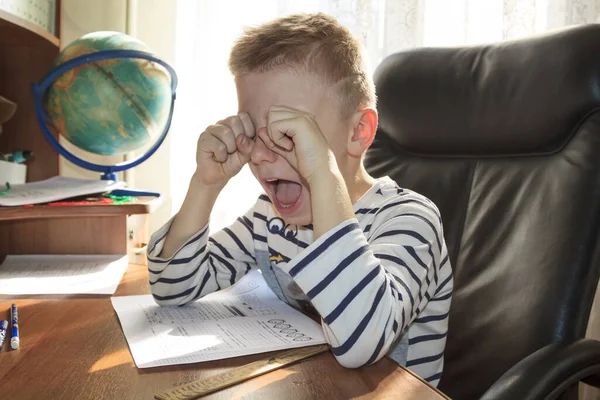 School-age boy crying and screaming while doing homework. the co Stock ...