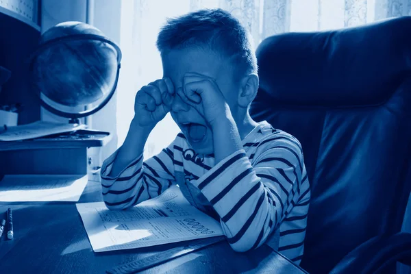 School-age boy crying and screaming while doing homework. the co Stock ...
