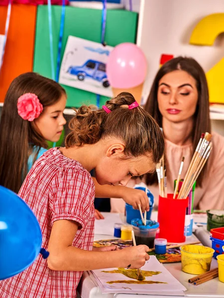 Break school in painting class. Small student painting in art school ...