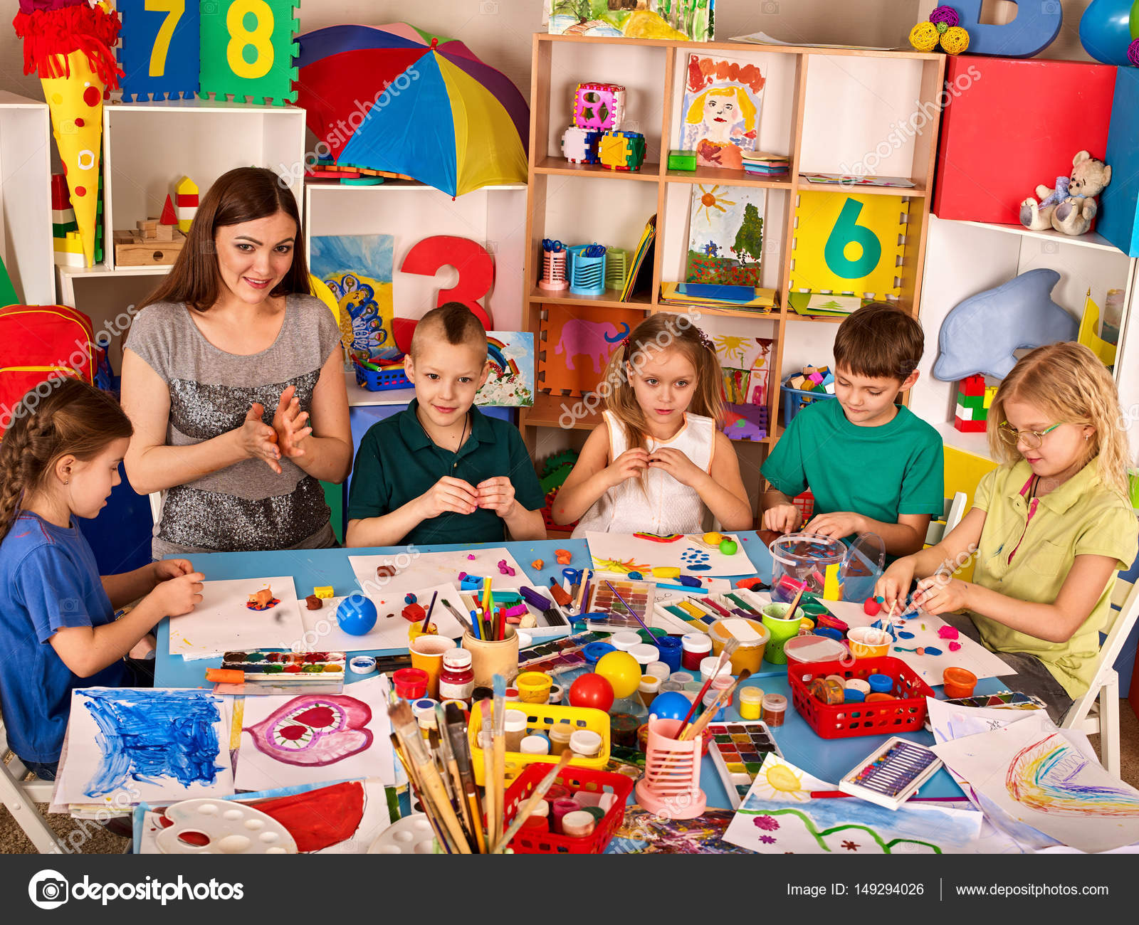 Plasticine modeling clay in children class. Teacher teaches in school ...