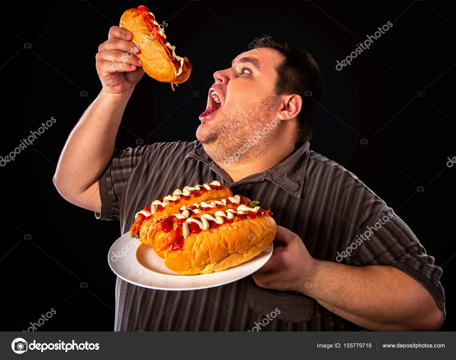 Fat man eating fast food hot dog. Breakfast for overweight person ...