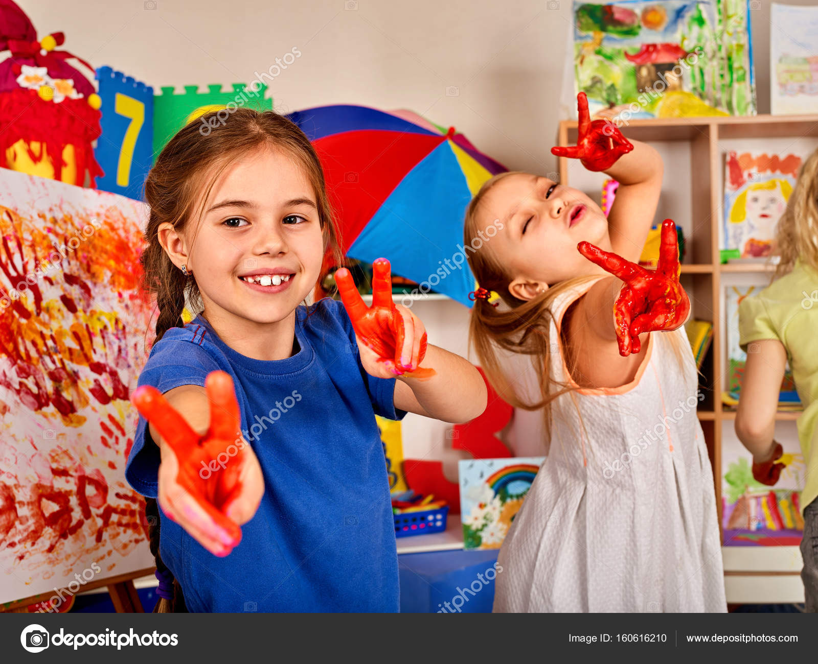 Children painting finger on easel. Small students in art school class ...