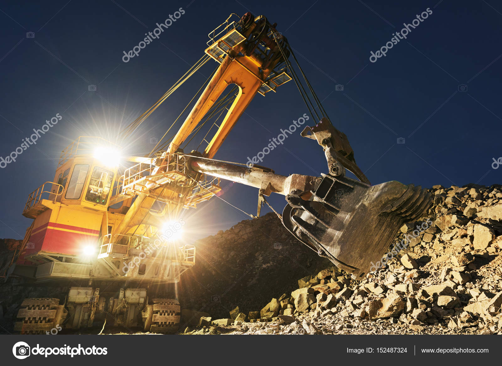 Mining construction industry. Excavator digging granite or ore in ...