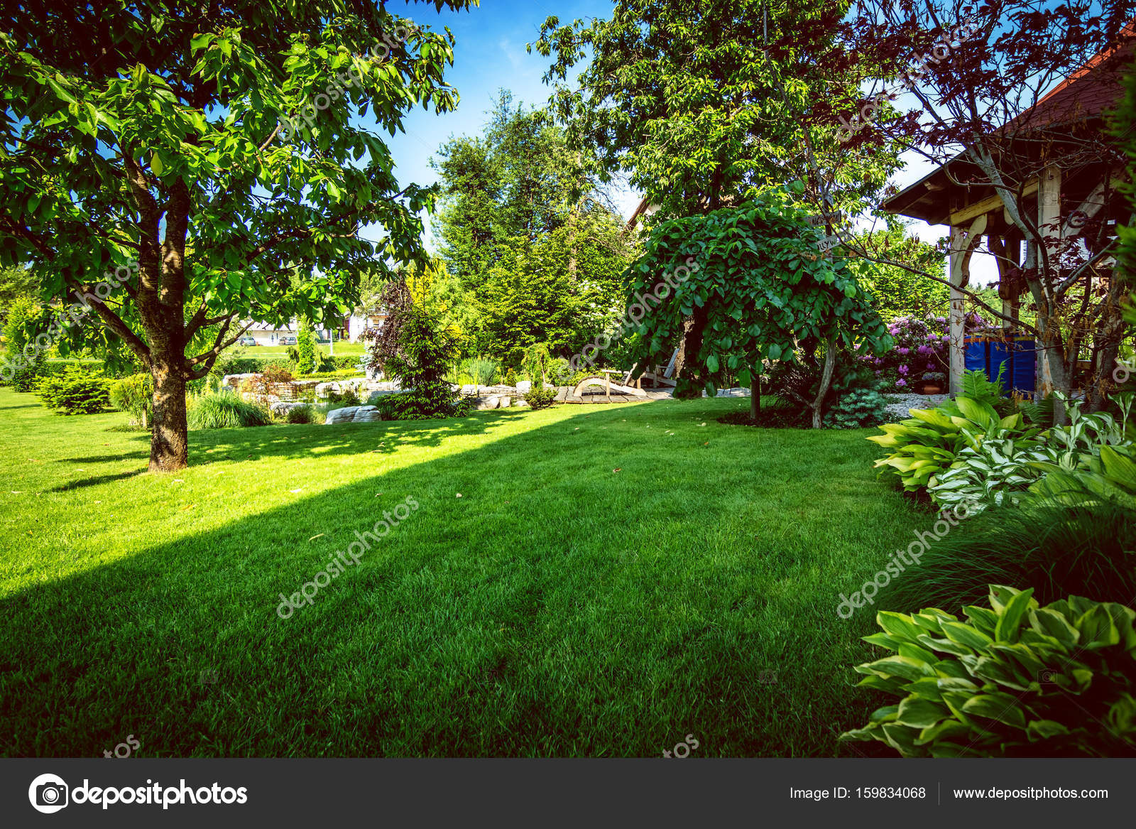 Garden Backyard with lush green grass Stock Photo by ©fotovincek 159834068