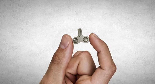 Key between fingers . Mixed media - Stock Image - Everypixel
