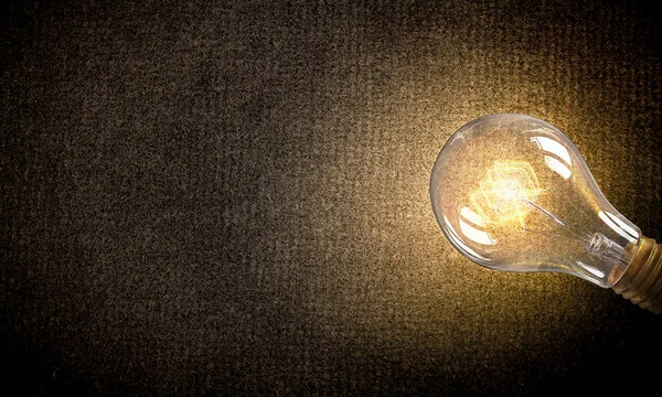 Light bulb on stone surface Stock Photo by ©SergeyNivens 112128106