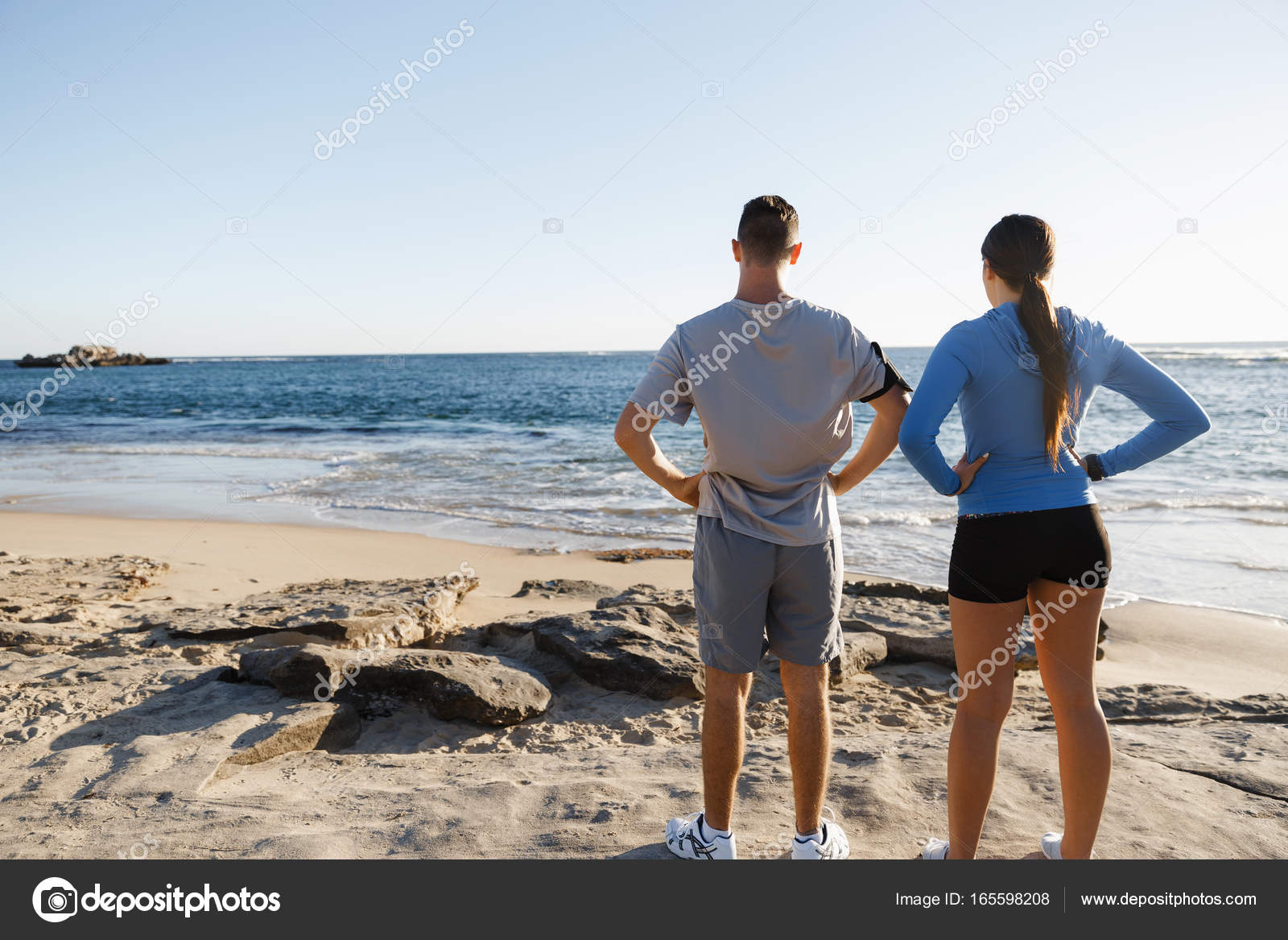 Young couple on beach training together — Stock Photo © SergeyNivens #165598208