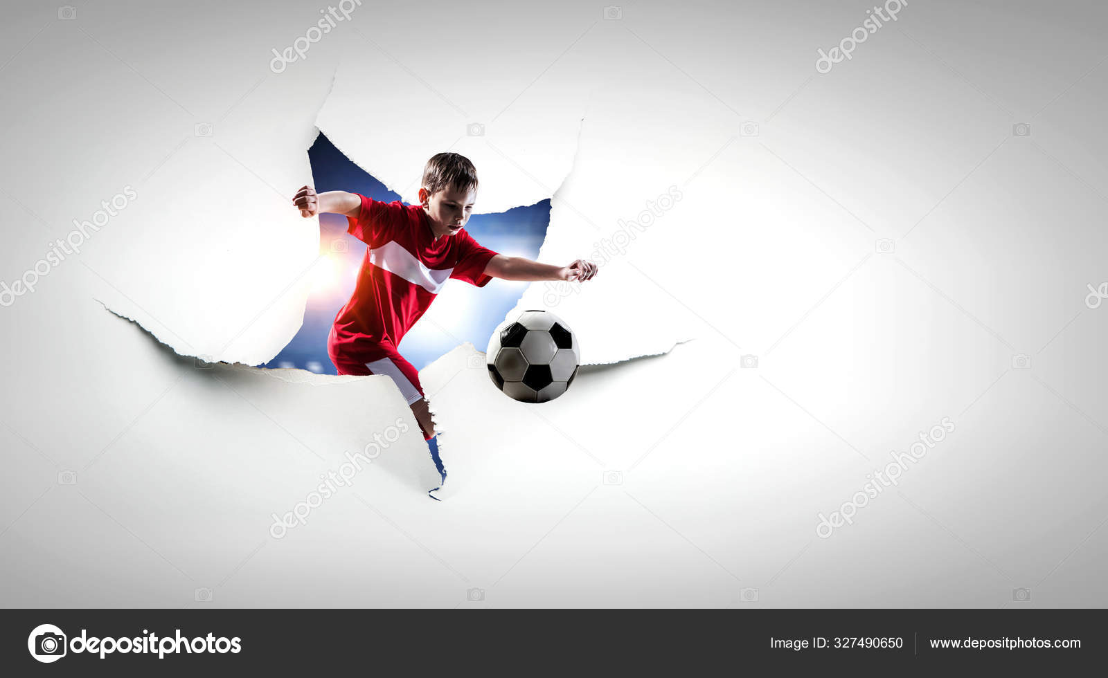 Kid footballer breaking through white paper. Mixed media — Stock Photo ...