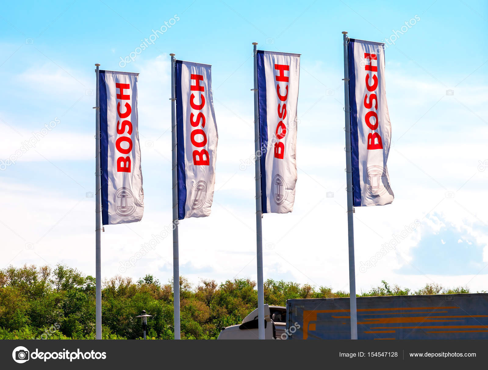 Flags with emblem Bosch against the blue sky — Stock Editorial Photo ...