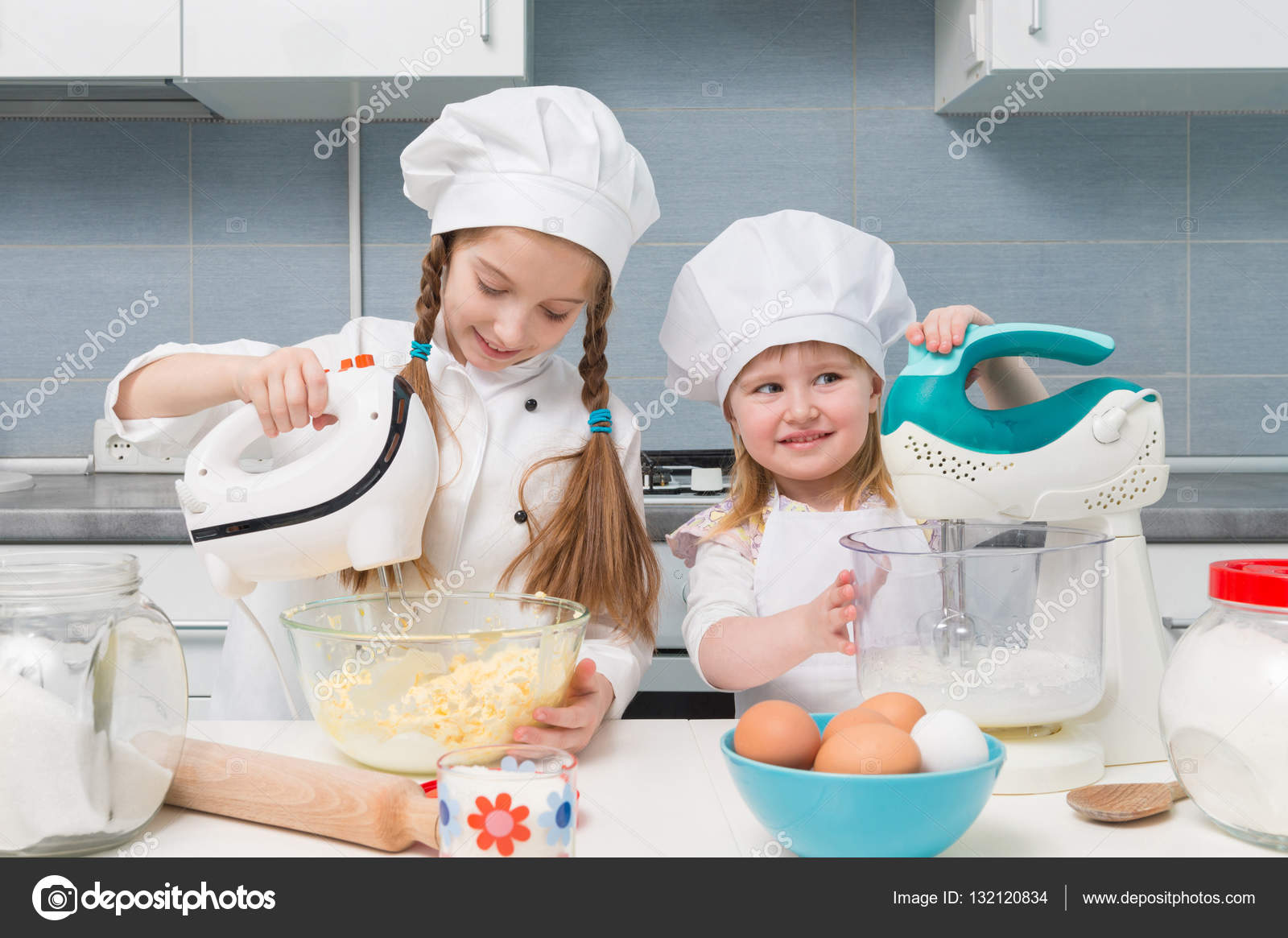 Two little girls in chef uniforms Stock Photo by ©tan4ikk 132120834