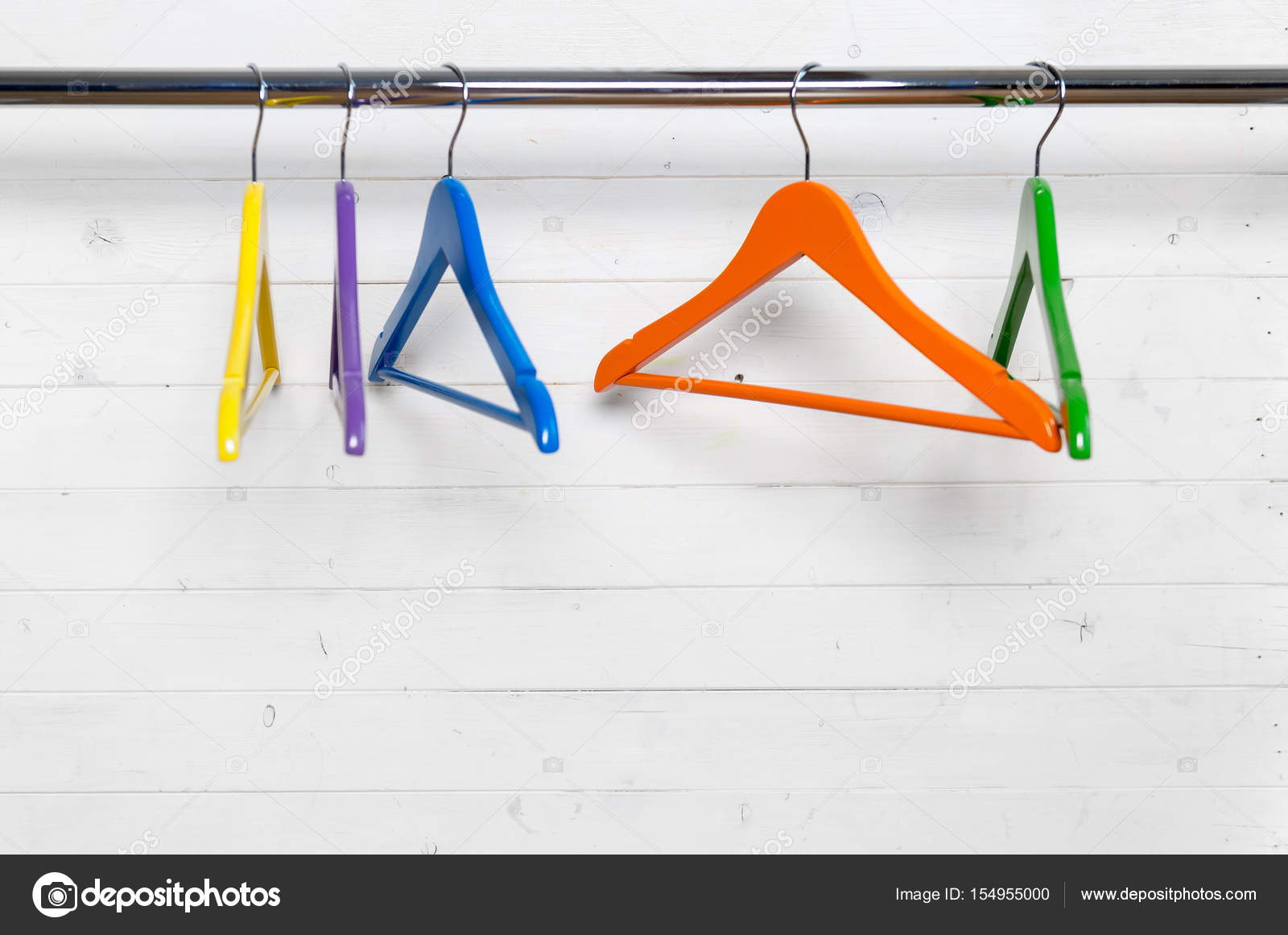 Multicolored hangers near the white brick wall Stock Photo by ©tan4ikk ...