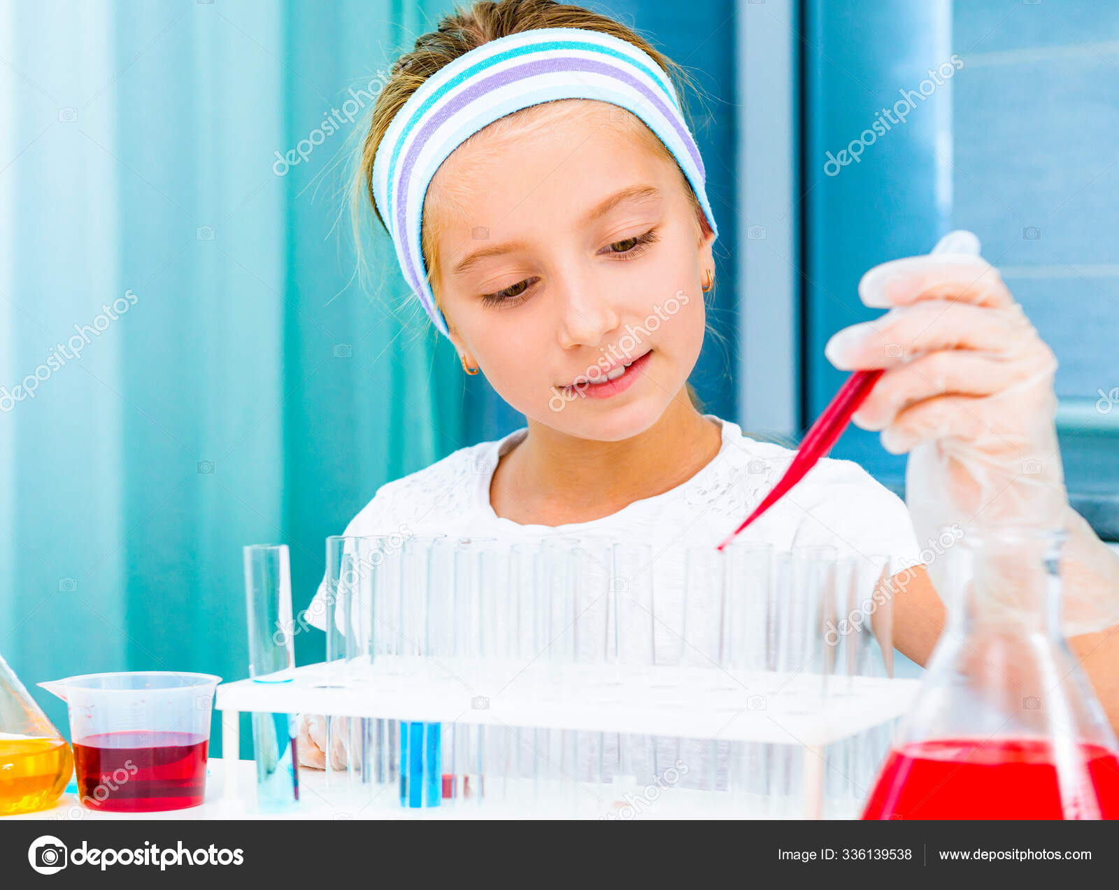 Little girl with flasks for chemistry Stock Photo by ©tan4ikk 336139538