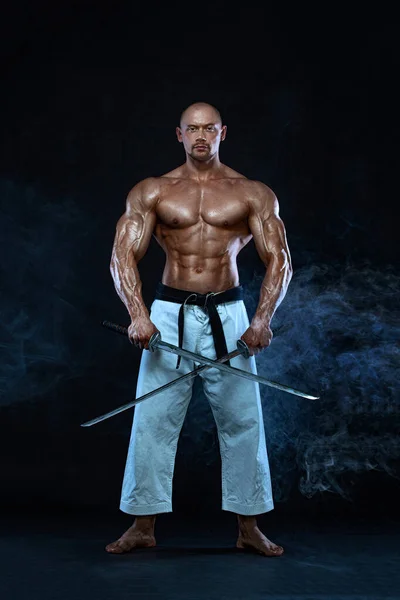 Shirtless man samurai with Japanese sword. Karate fighter on black ...