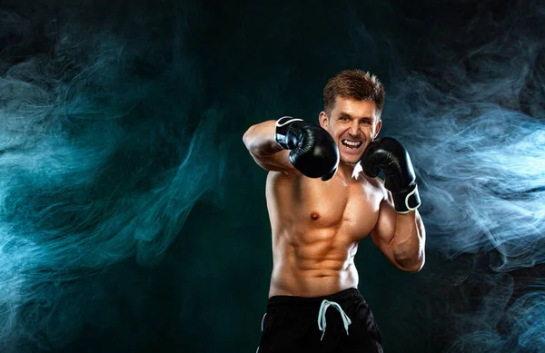 Boxer, man fighting or posing in gloves on black background. Fitness ...