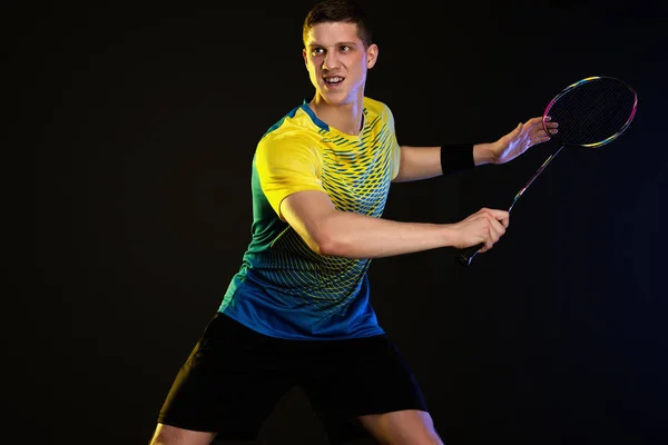 Badminton player in sportswear with racket and shuttlecock on stadium ...
