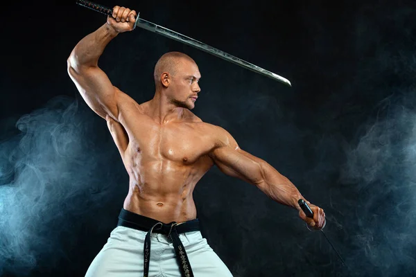 Shirtless man samurai with Japanese sword. Karate fighter on black ...