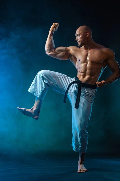 Shirtless man samurai with Japanese sword. Karate fighter on black ...