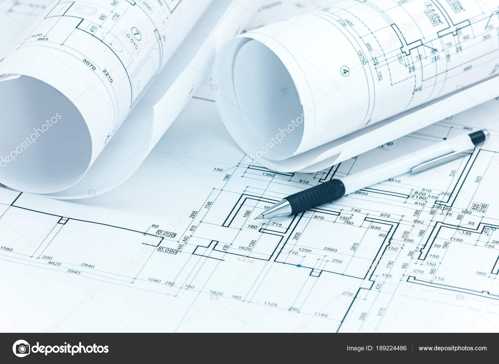 Architectural plans, blueprint rolls and pencil on architect desk ... Architectural plans, blueprint rolls and pencil on architect desk ...