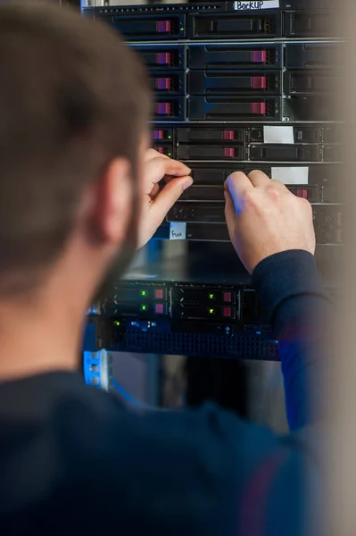 network engineer working in server room - Stock Image - Everypixel