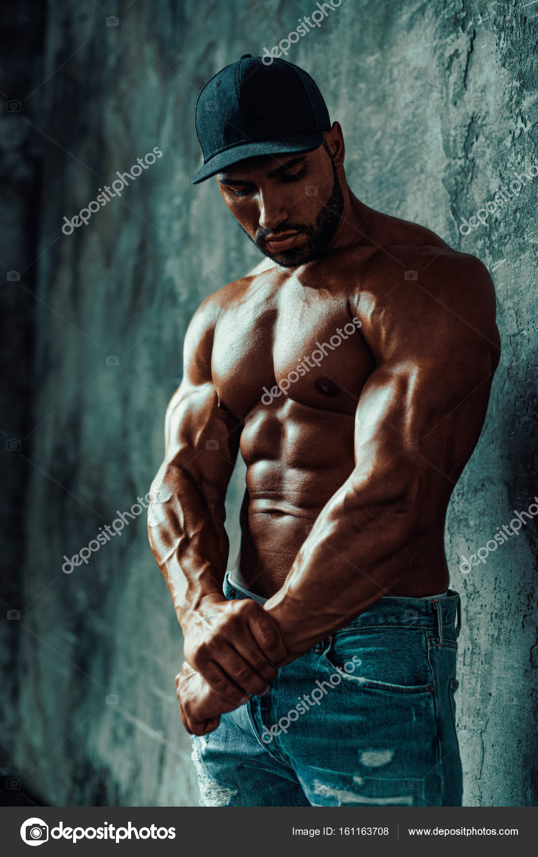 Strong man on dark wall background — Stock Photo © chaoss #161163708