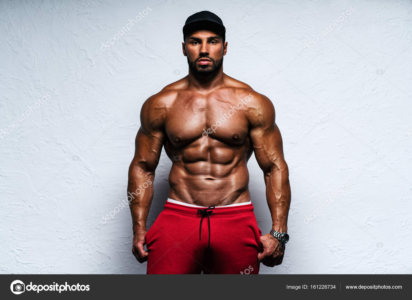 Strong man on white wall background — Stock Photo © chaoss #161226734