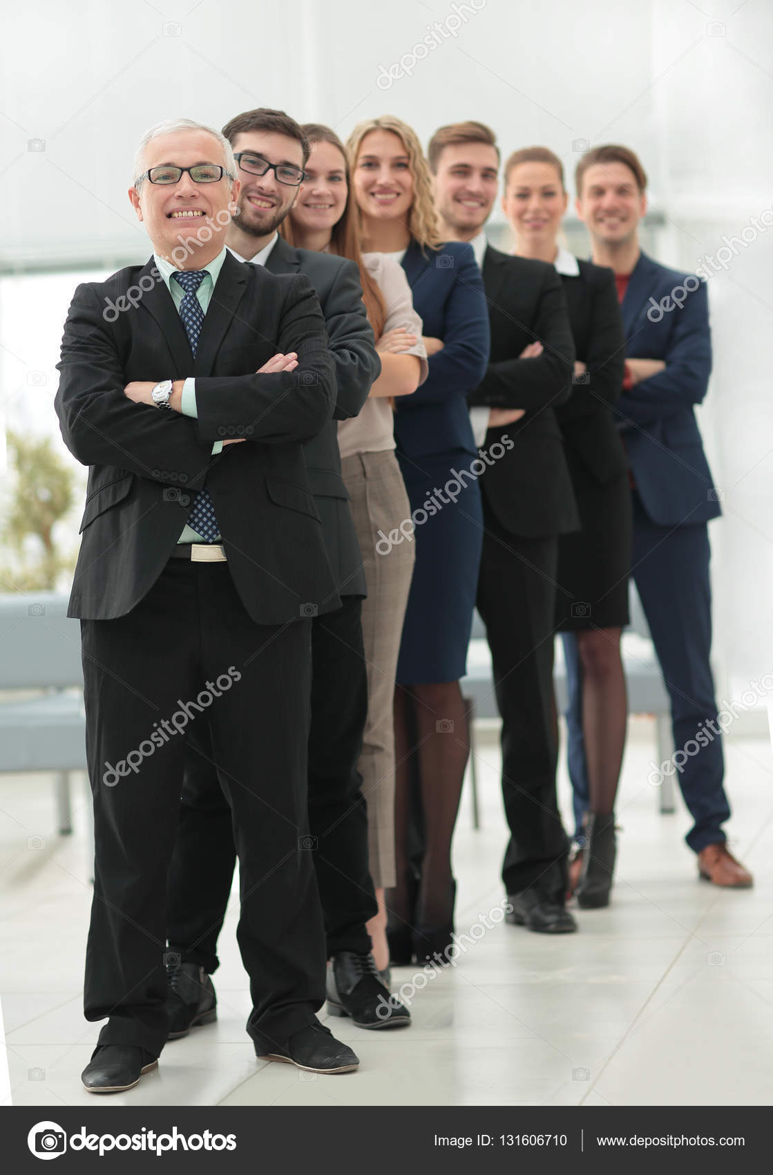 Successful team of staff standing in a row — Stock Photo © depositedhar ...