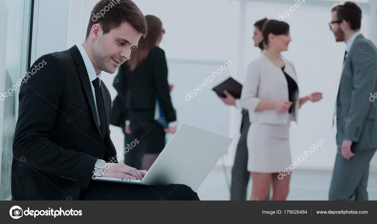 Communication concept:businessman working with laptop on the kne ...
