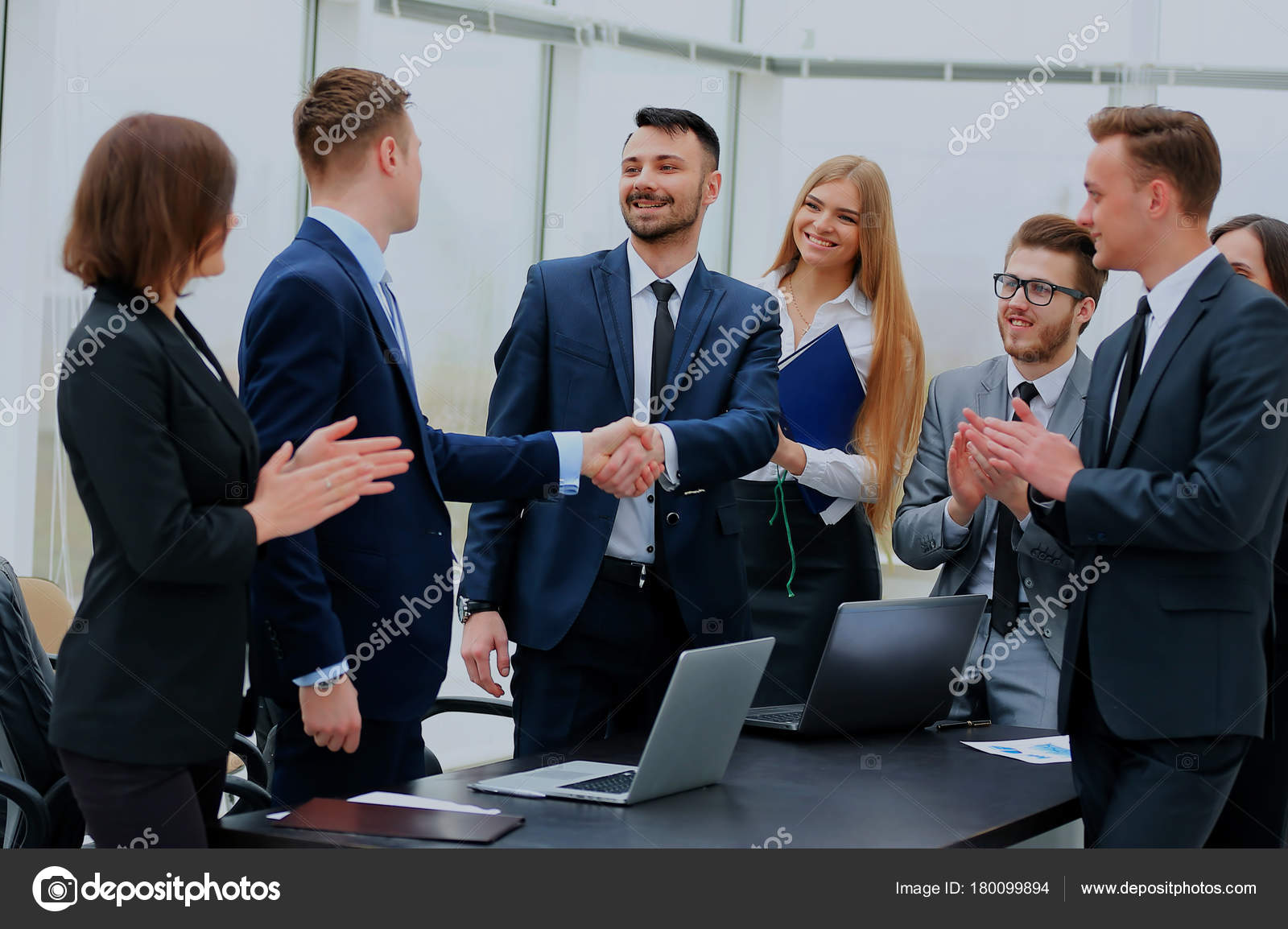 Two professional business people shaking hands. Stock Photo by ...