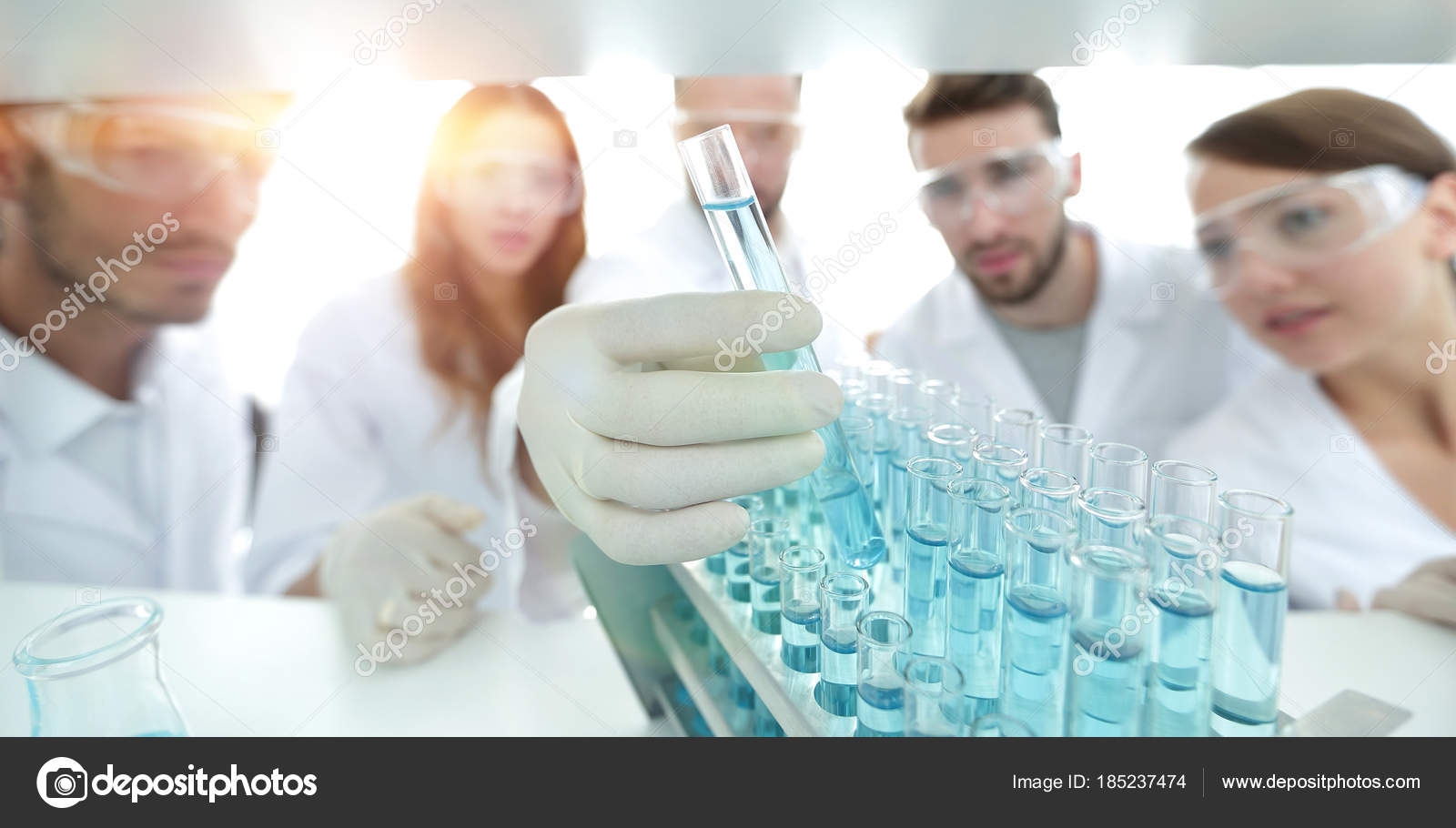 Background image is a group of microbiologists studying the liqu Stock ...