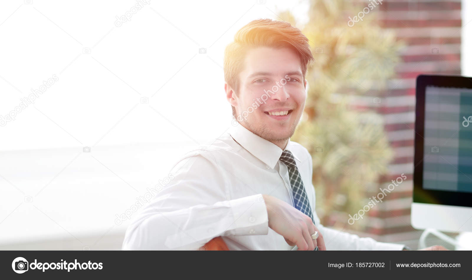 Employee sitting in front of a computer screen Stock Photo by ...