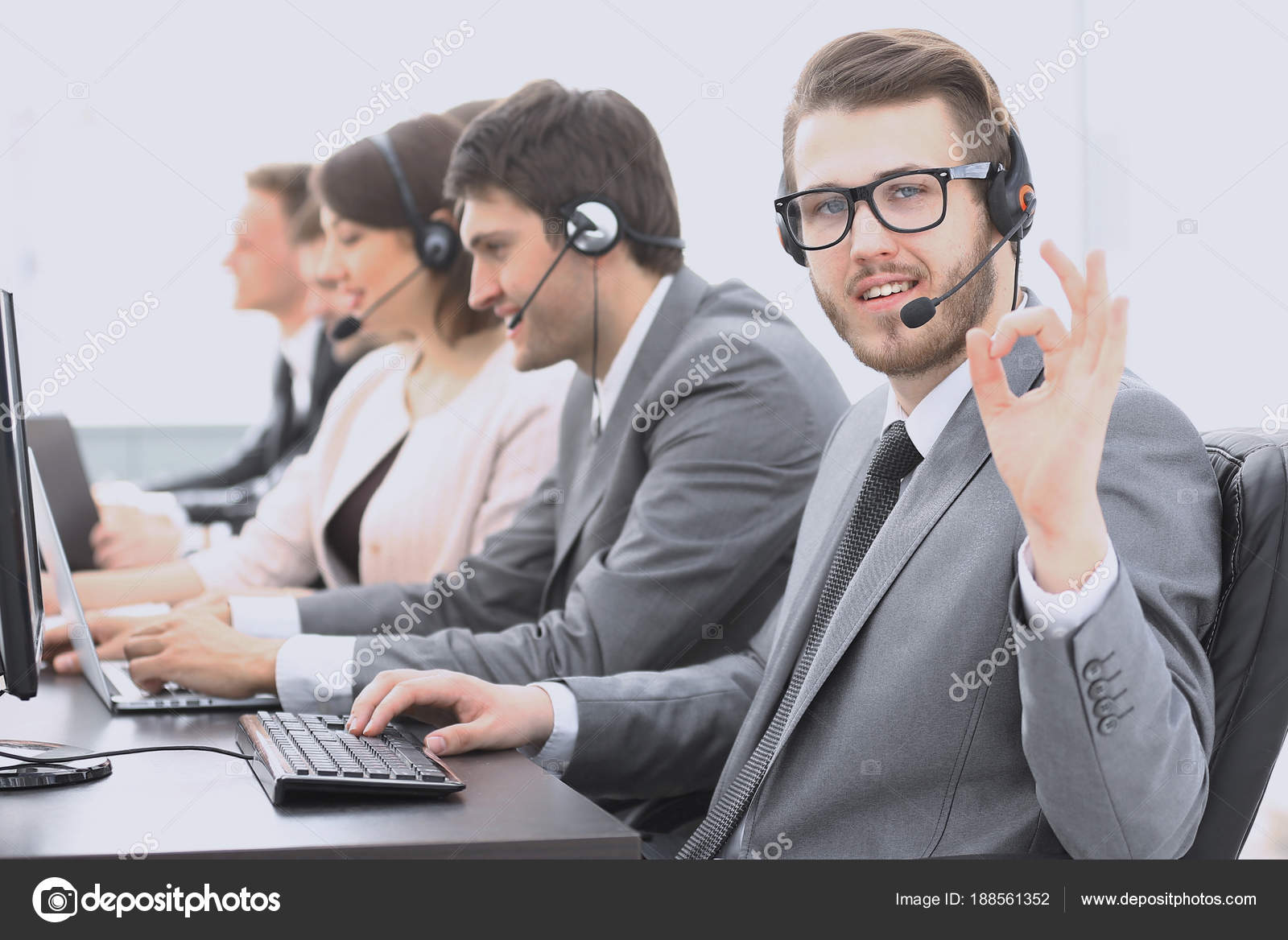 Customer service representative with headset showing sign "OK" — Stock ...