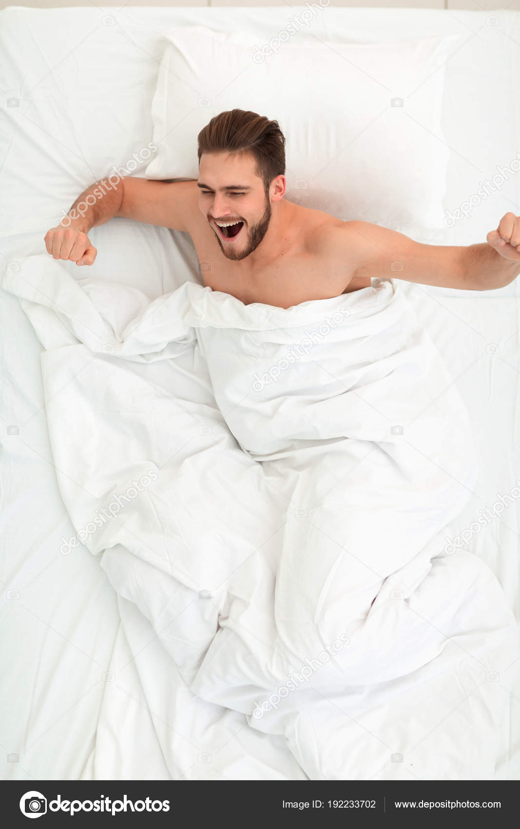 Top view. happy man waking up in a comfortable bed Stock Photo by ...