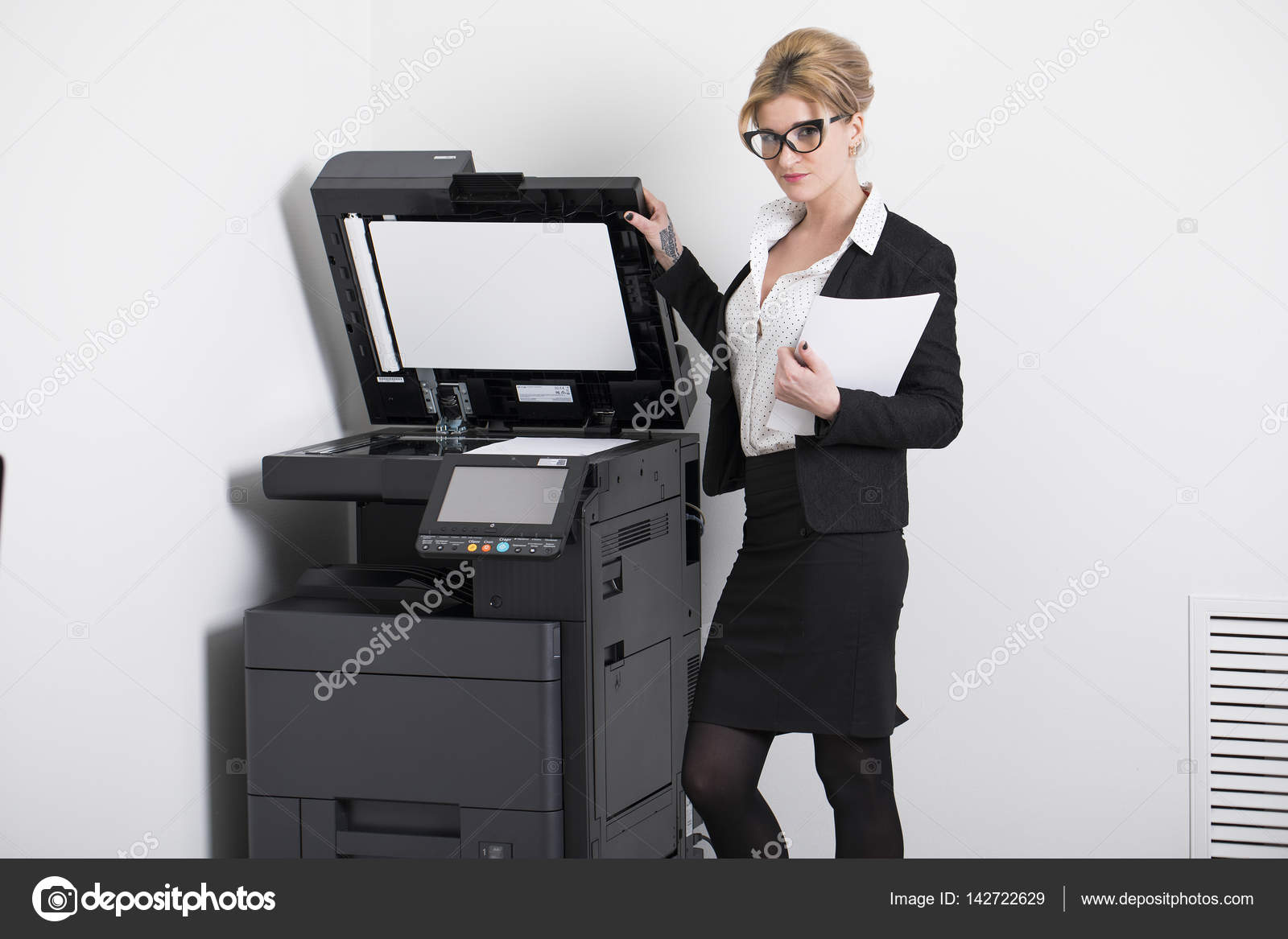 Young beautiful woman making copies in the office Stock Photo by ...