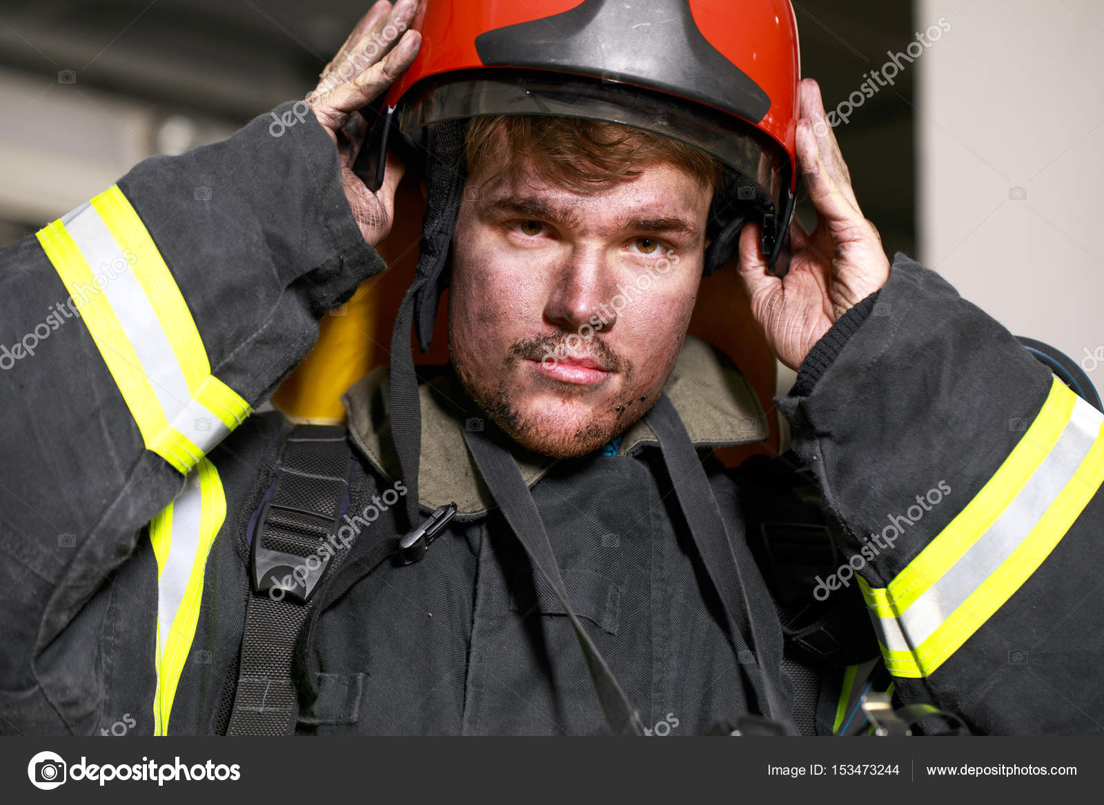 Portrait of a young fireman on the background of a fire truck Stock ...