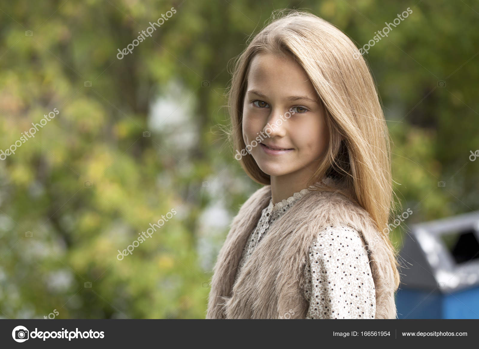 Portrait of a beautiful young little girl Stock Photo by ©arkusha 166561954