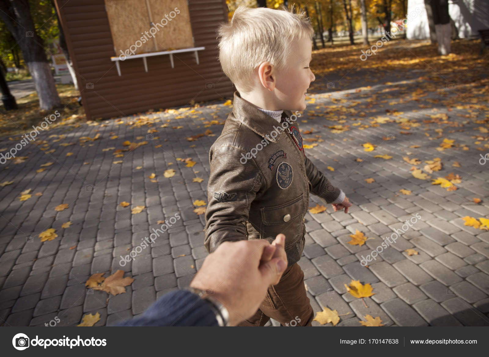 Follow me, Beautiful little boy holds the hand of a father Stock Photo ...