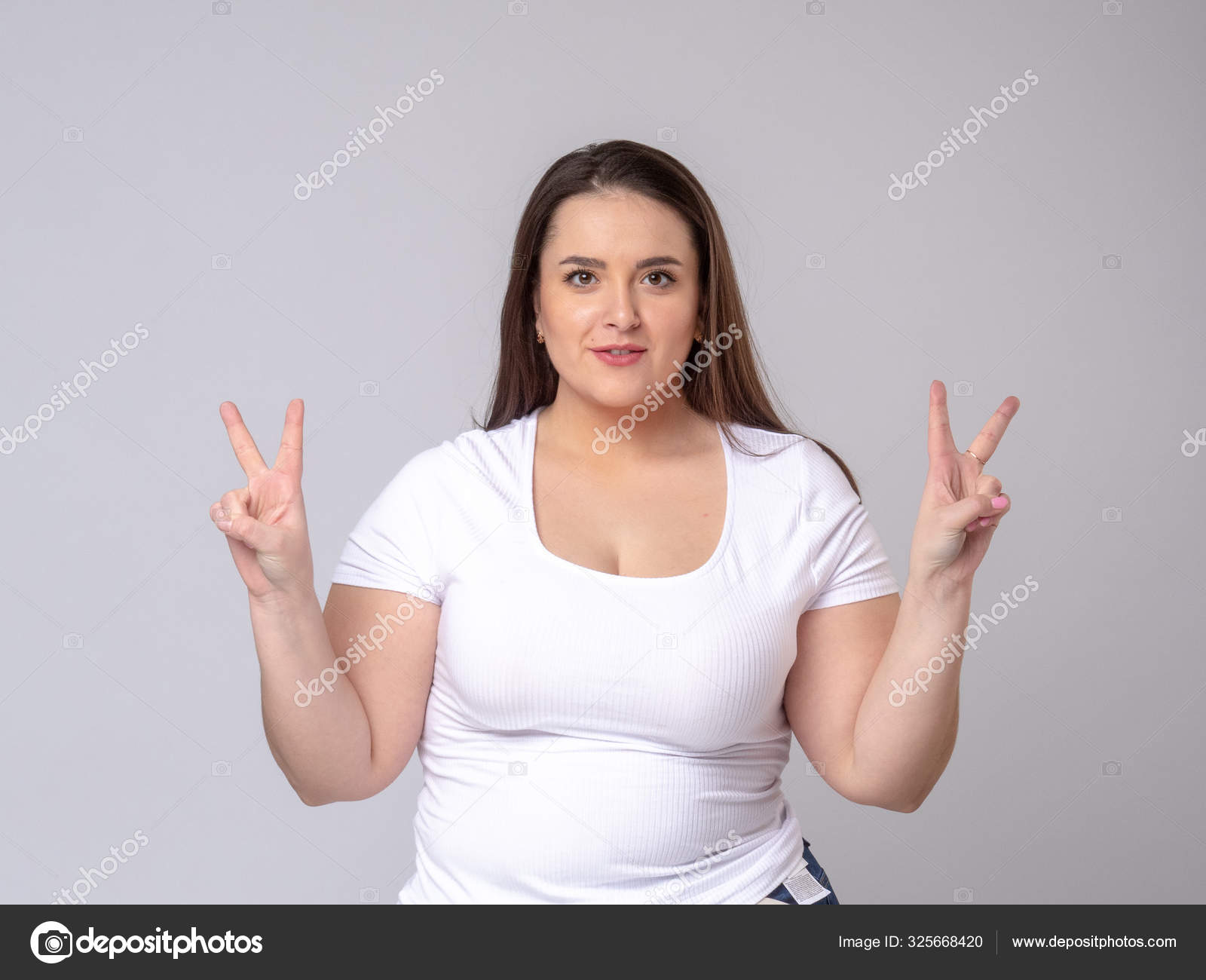 Shocked Plus Size Model with long hair posing in studio. v -symbol ...