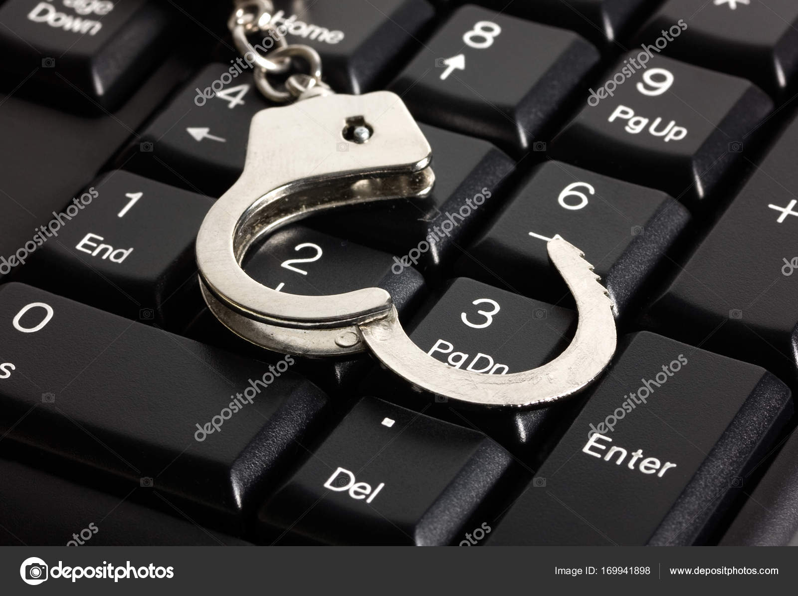 Computer keyboard and handcuffs Stock Photo by ©fotoall 169941898