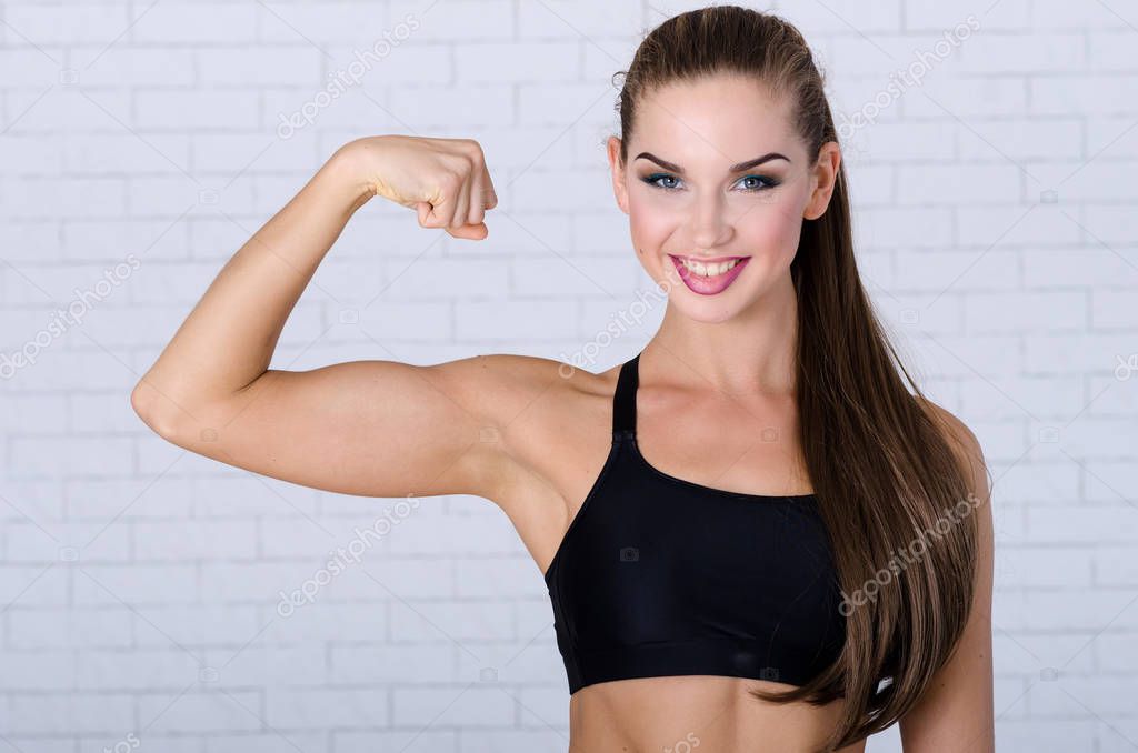 Woman shows her biceps Stock Photo by ©rainfall 129240714