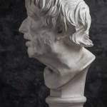 Gypsum copy of ancient statue Seneca head on dark textured background ...