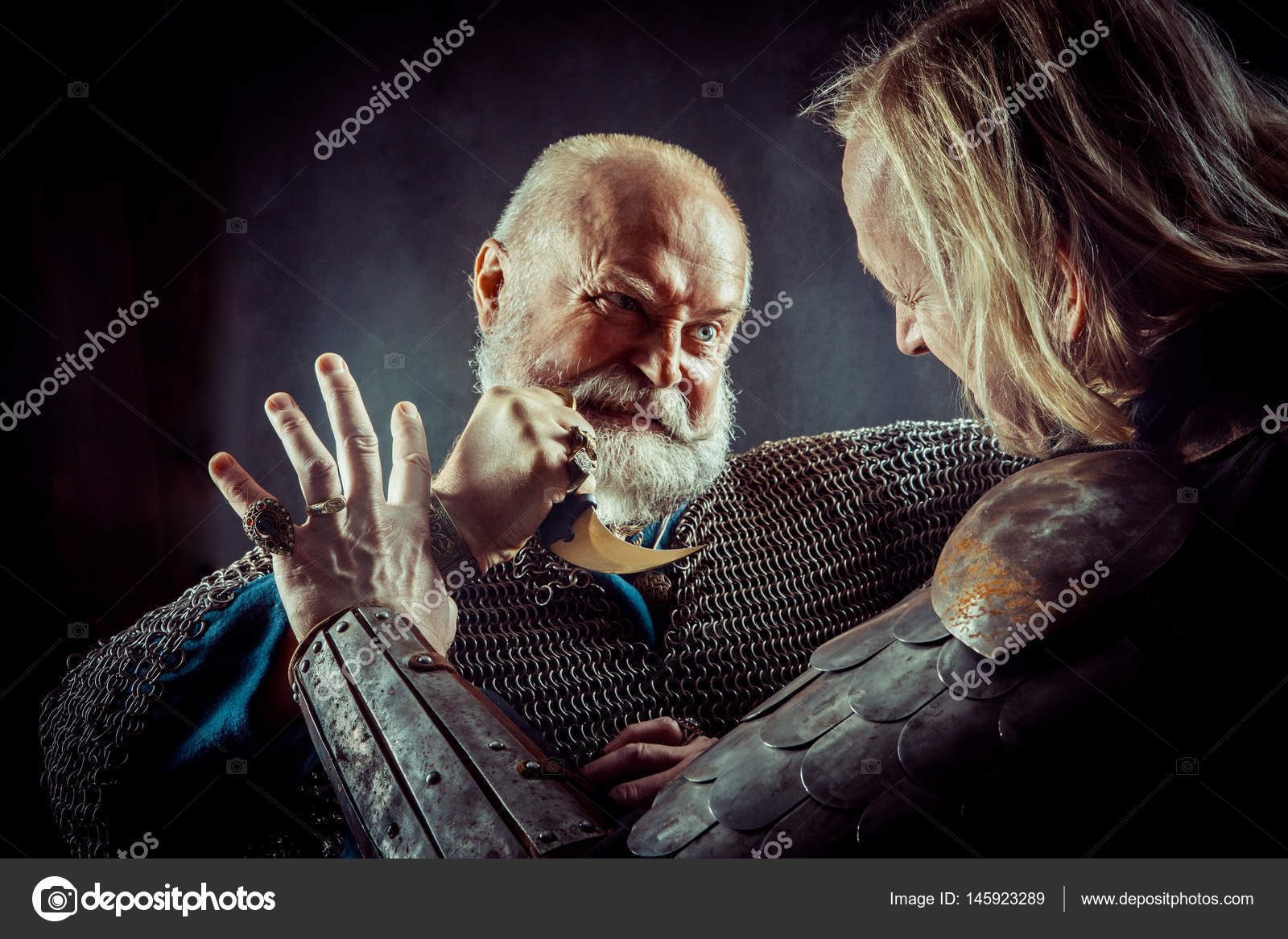 Dagger fight between two medieval knights on the dark background Stock ...