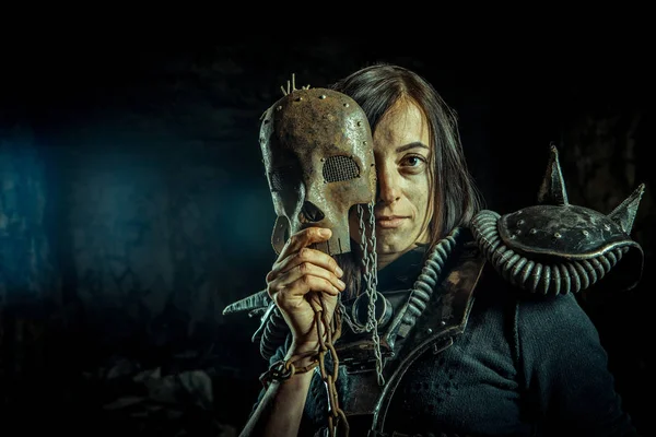 Post-apocalyptic woman in the rusty skull mask on the dungeon ...