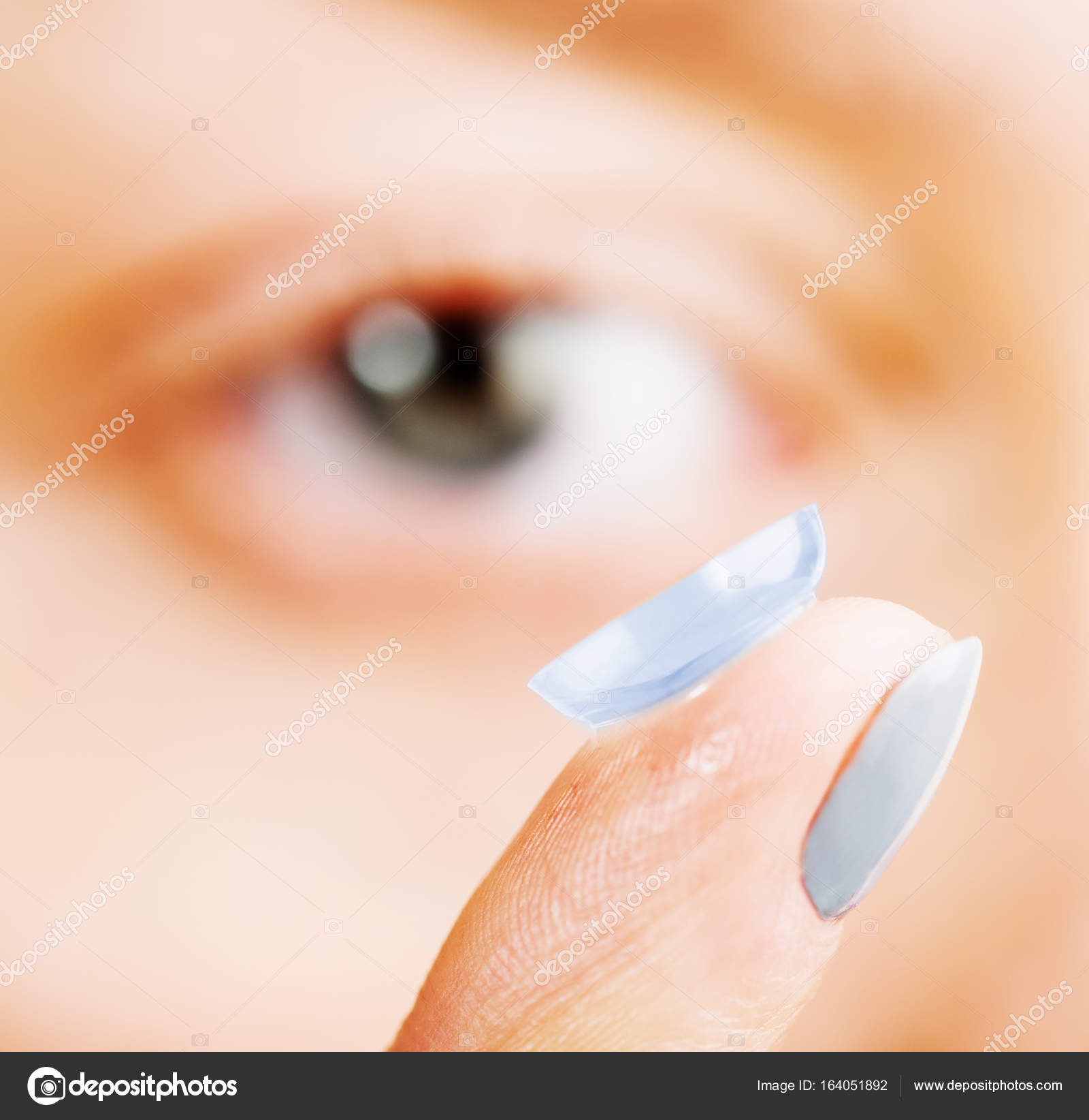Inserting contact lens in eye Stock Photo by ©valphoto 164051892