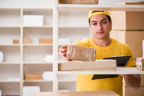 Man working in postal parcel delivery service office - Stock Image ...